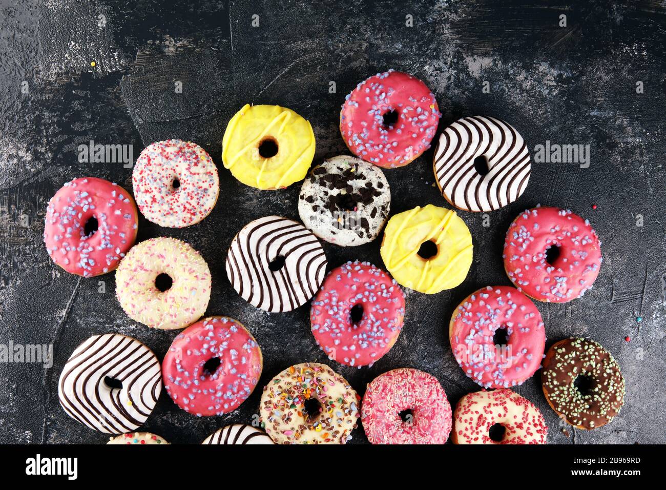 assorted donuts with chocolate frosted, pink glazed and sprinkles ...