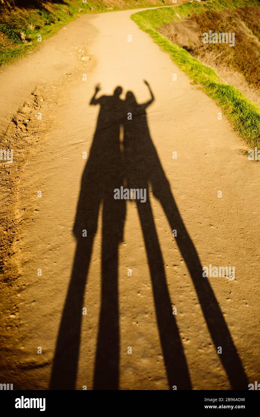 Couple waving in shadow on hiking trail. Griffith Park, Los Angeles, CA ...