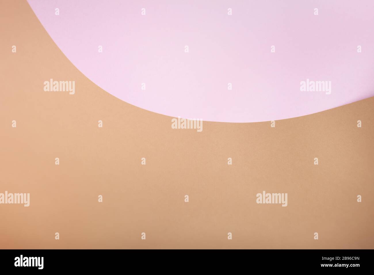Pink and brown abstract paper background from a curved sheet. Blank for ...