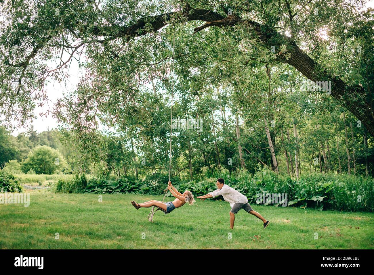 Young man pushing two women hi-res stock photography and images - Alamy