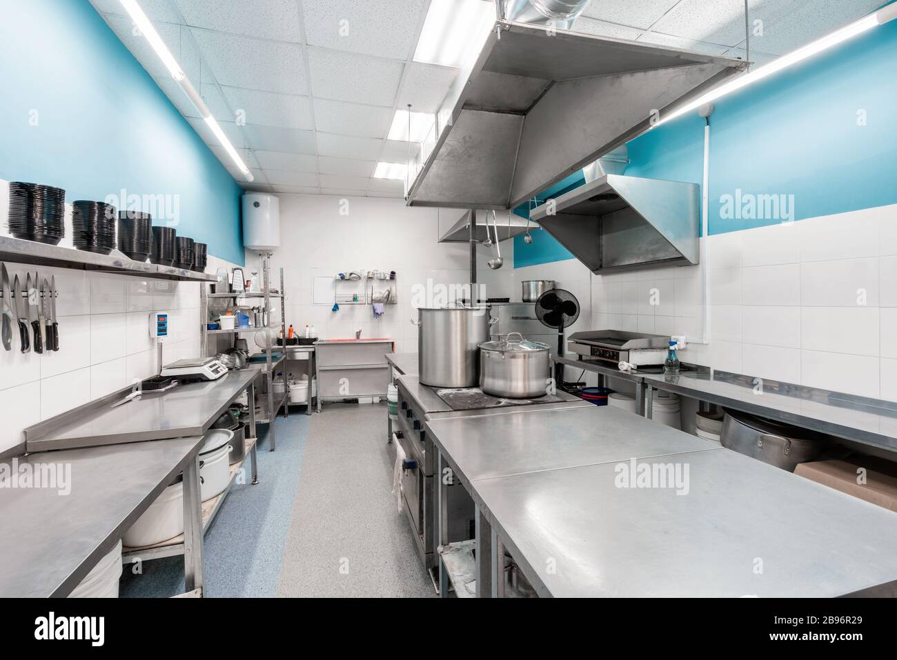 Modern restaurant kitchen with stainless steel kitchenware and ...