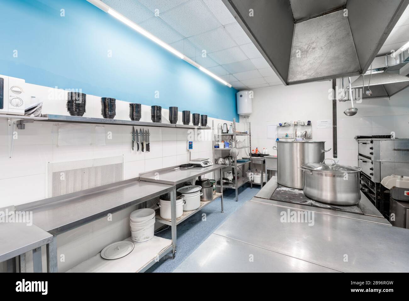 Modern restaurant kitchen with stainless steel kitchenware and ...