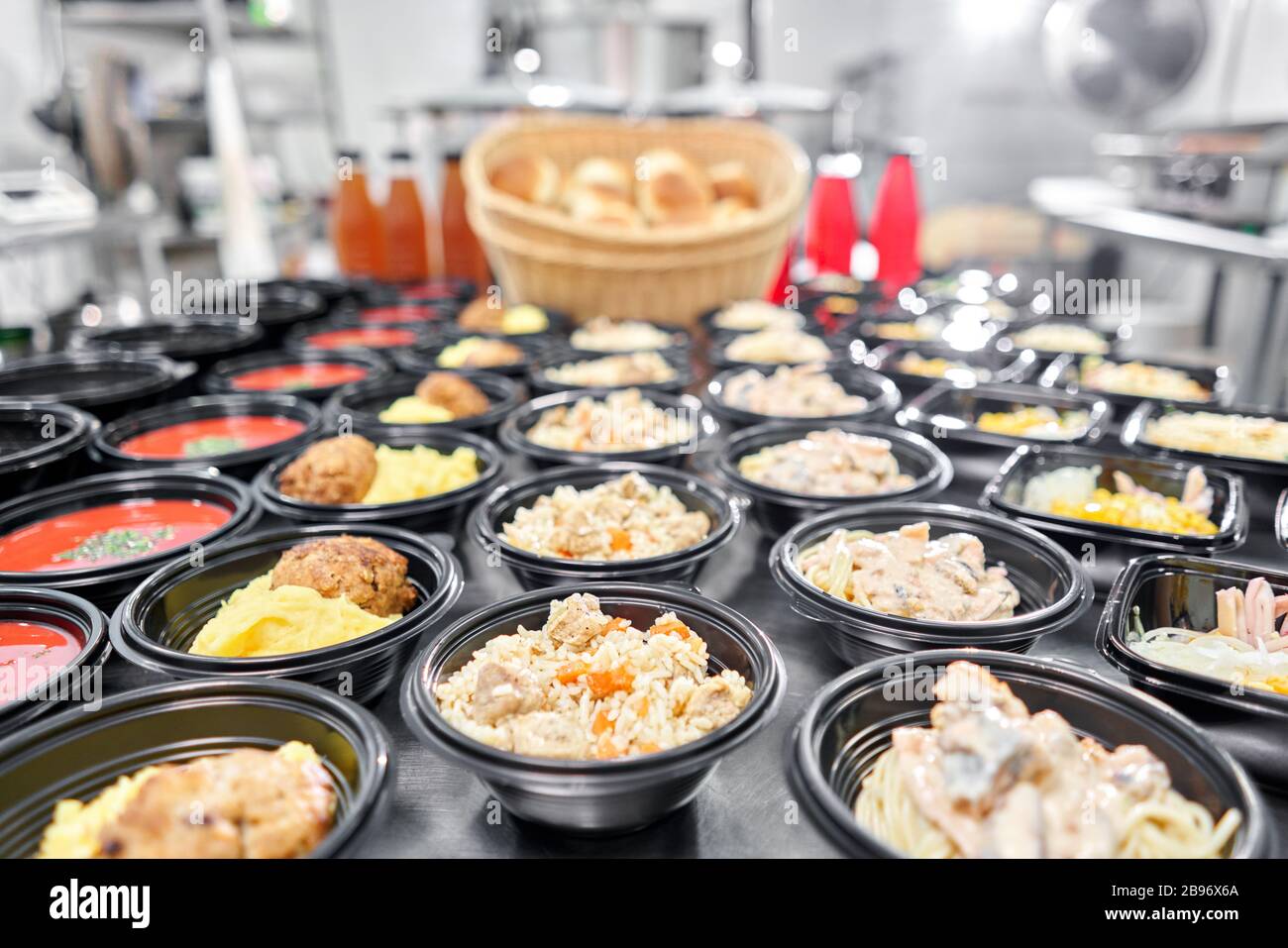 Row of plastic disposable lunch box with healthy natural food. Soups ...