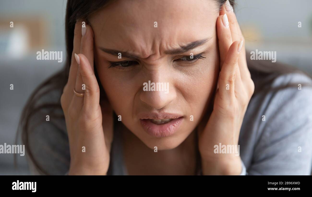 Unhealthy girl touch temples suffering from migraine Stock Photo - Alamy