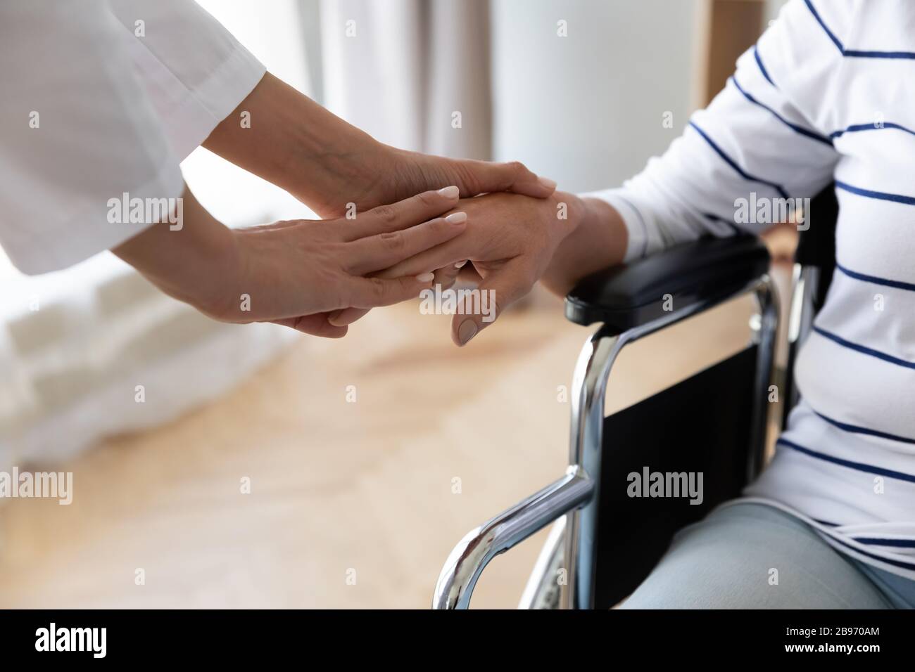 Female nurse take care of senior disabled woman patient Stock Photo - Alamy