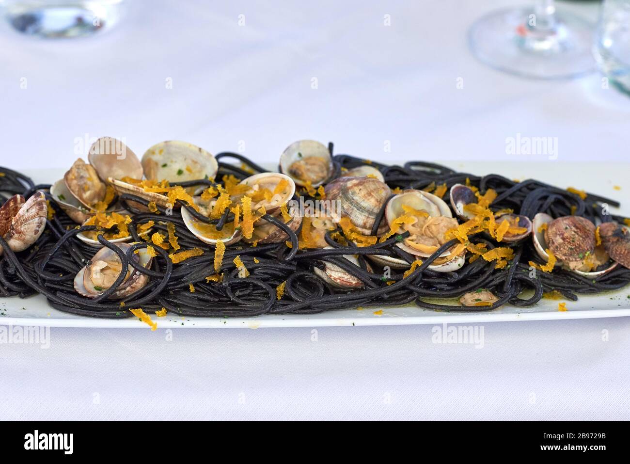 spaghetti with cuttlefish ink with clam sauce and bottarga Stock Photo ...