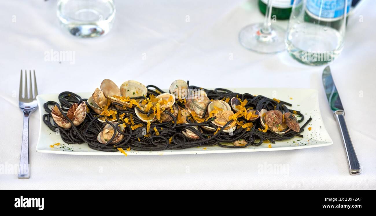 spaghetti with cuttlefish ink with clam sauce and bottarga Stock Photo ...