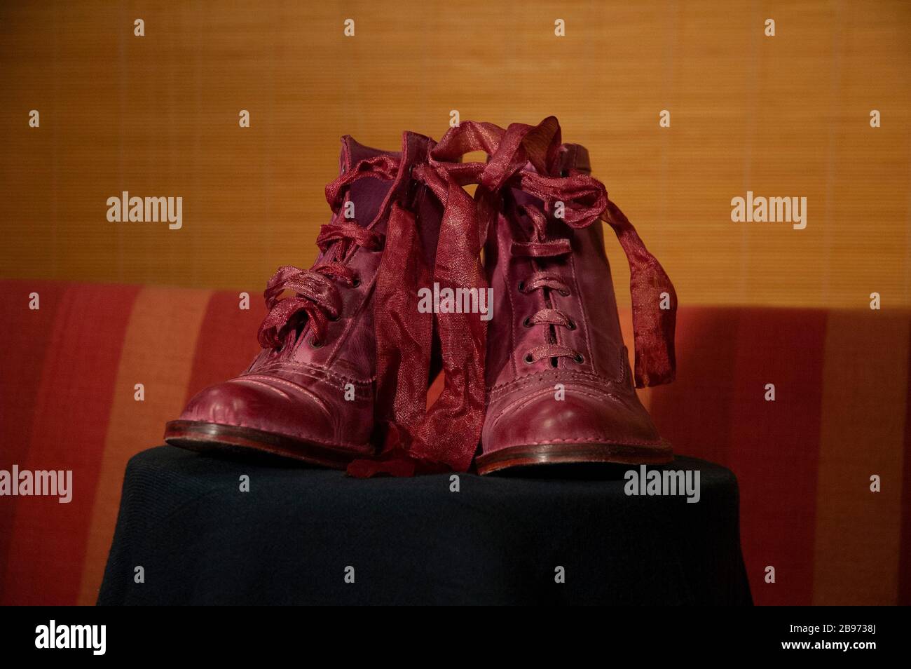 Red boots with silk laces and orange stripe background Stock Photo - Alamy