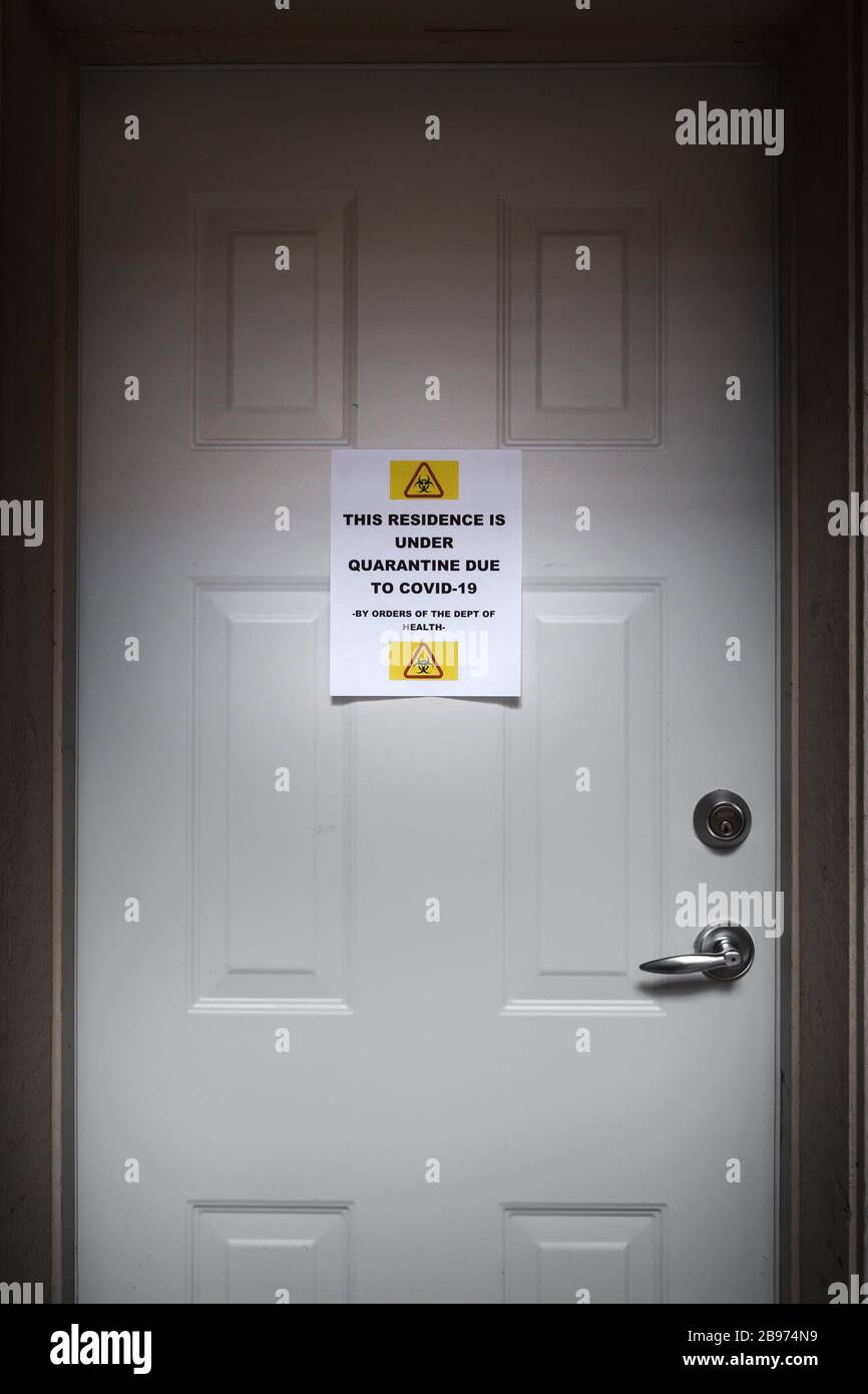 A self isolating residence with a quarantine sign on the front door ...