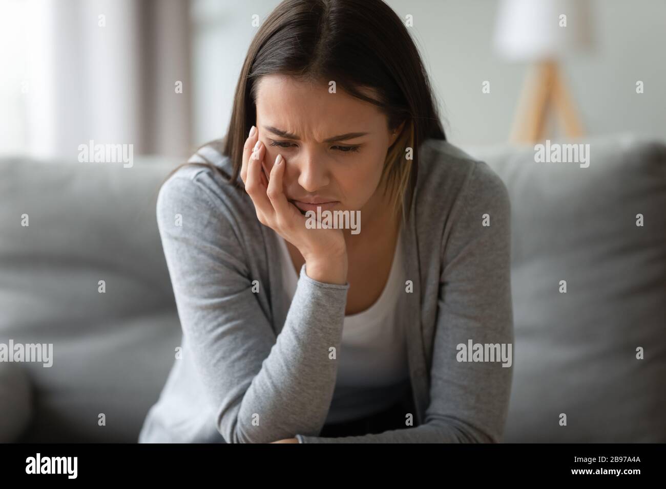 Upset young woman feel depressed at home Stock Photo - Alamy