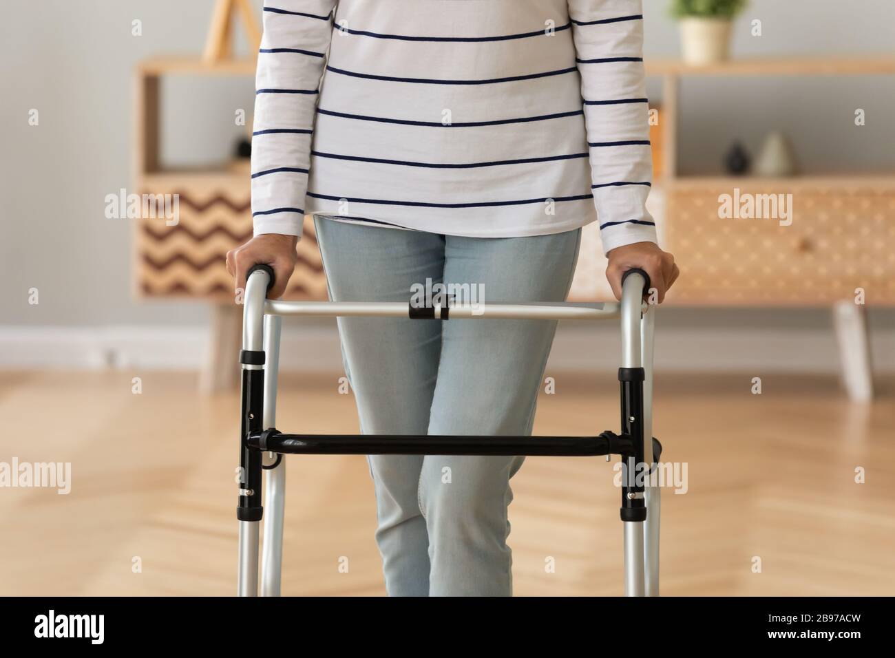 Disabled senior woman make steps with walker Stock Photo - Alamy