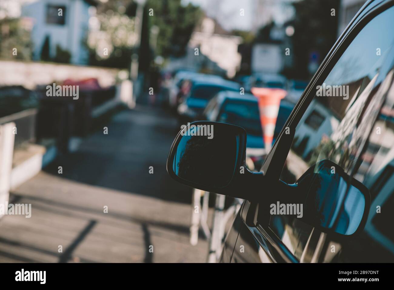 Side view of black mini van car parked on the empty street focus in the ...