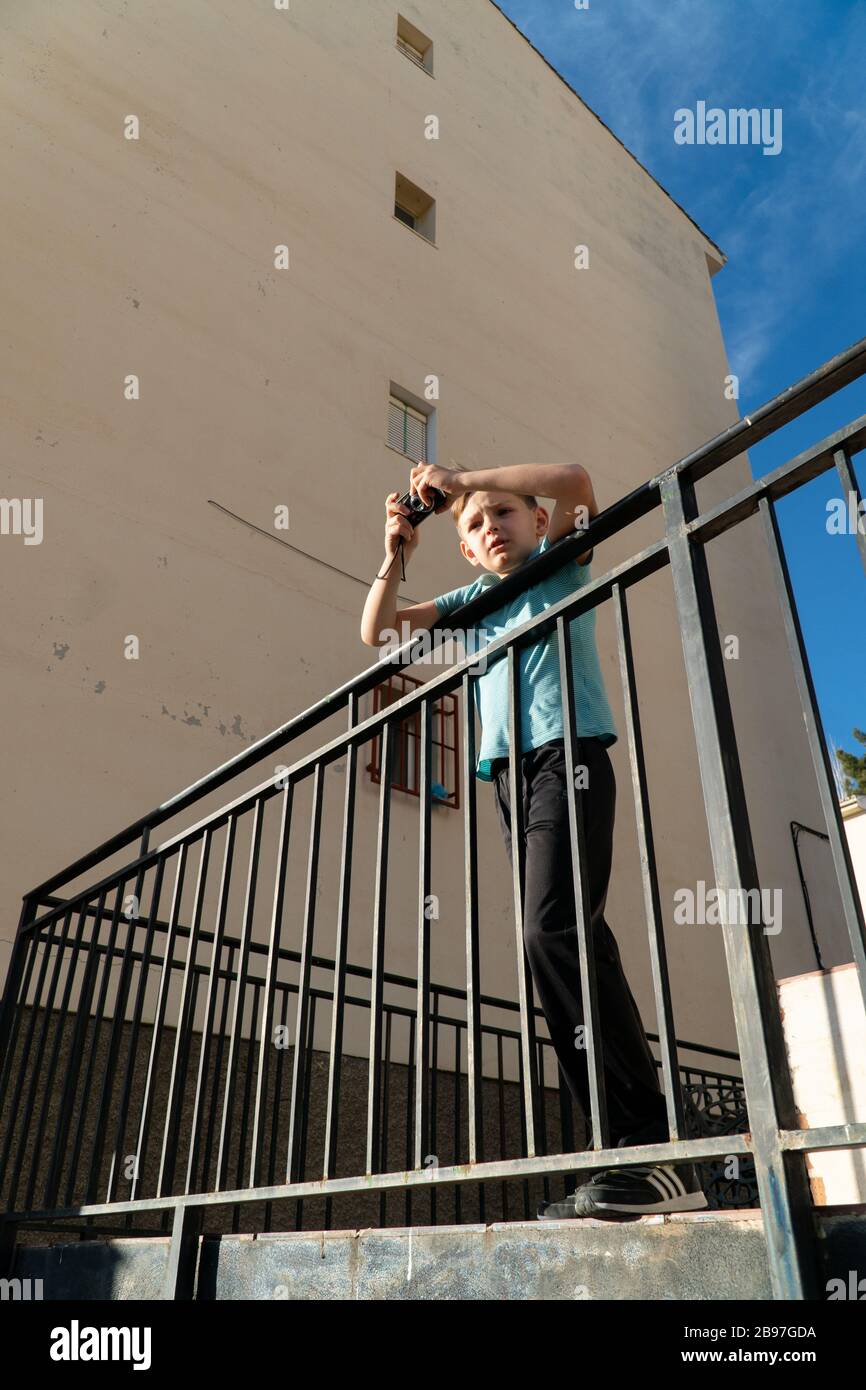 Handsome young cute little boy taking photo with digital camera. Bottom ...