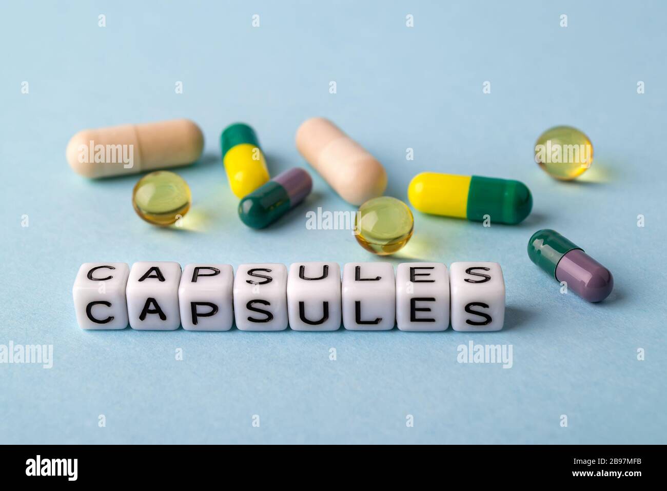 Word Capsules made of white cubes and different capsules on a blue ...