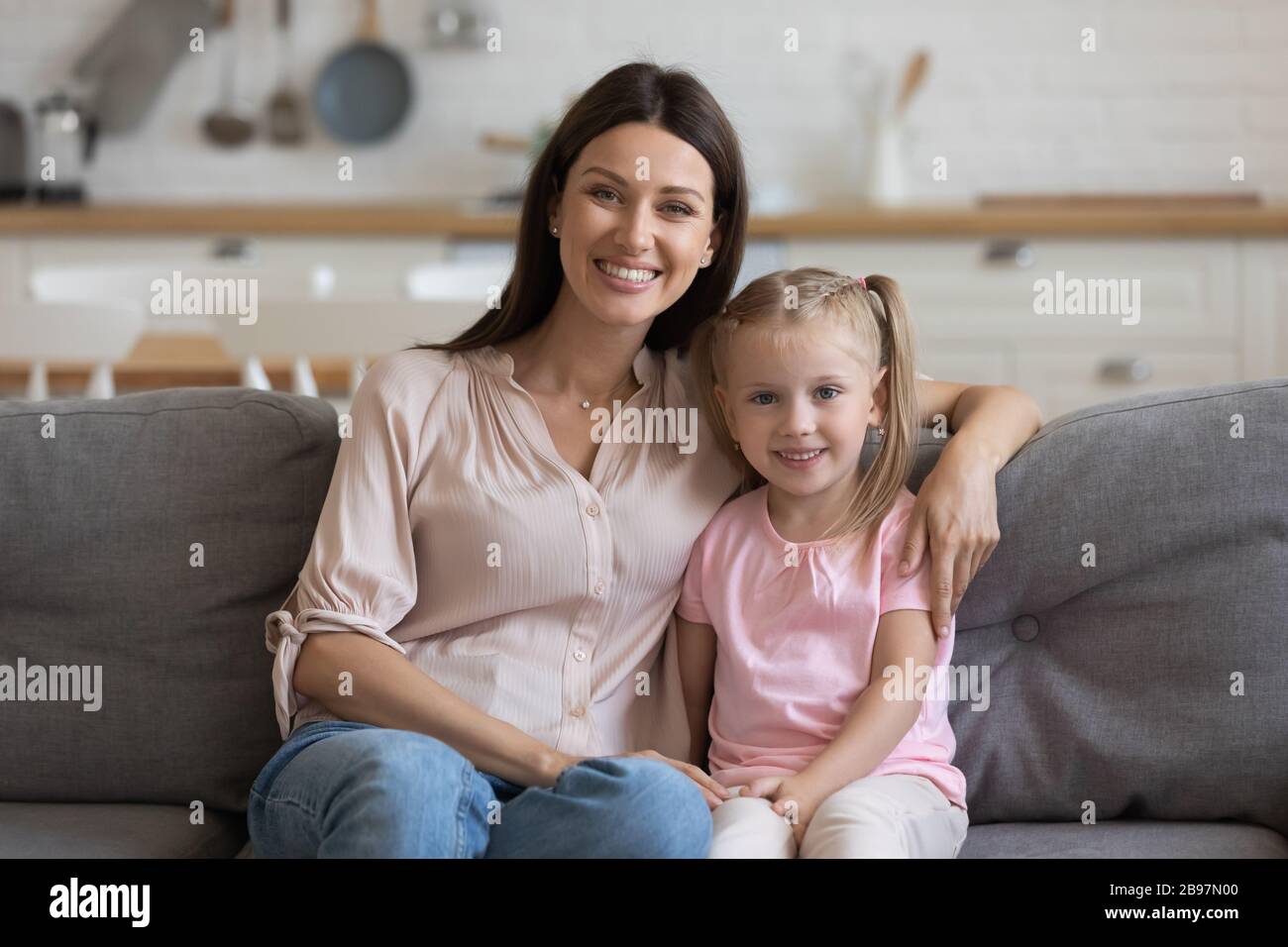 Portrait of happy mom and daughter cuddle at home Stock Photo - Alamy