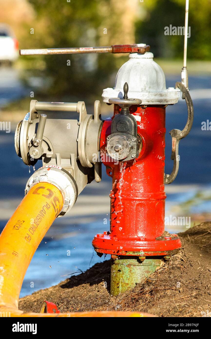 Fire hydrant water supply during emergency hooked to hose at day Stock ...