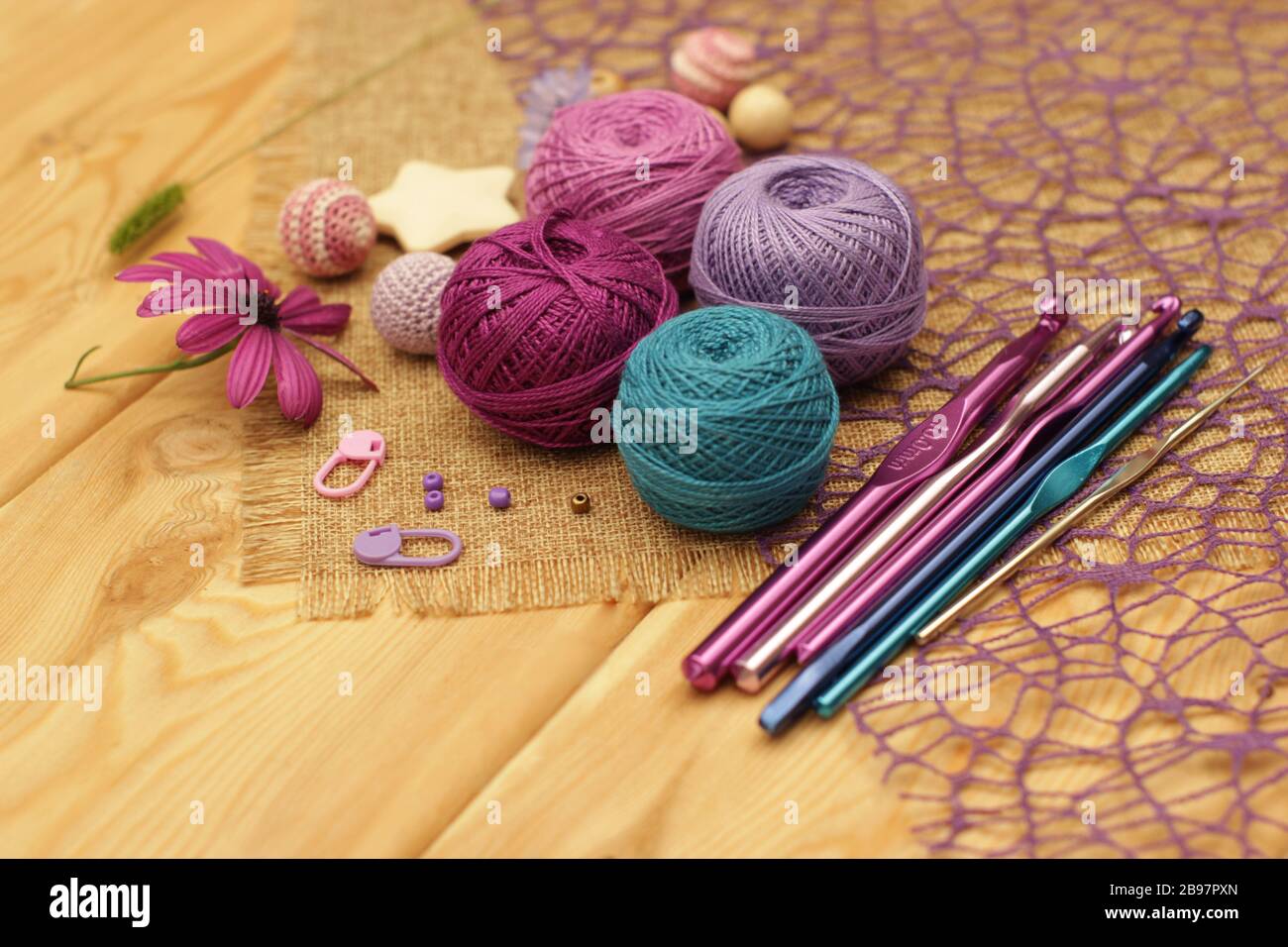 colorful yarn for knitting on a brown wooden table Stock Photo - Alamy