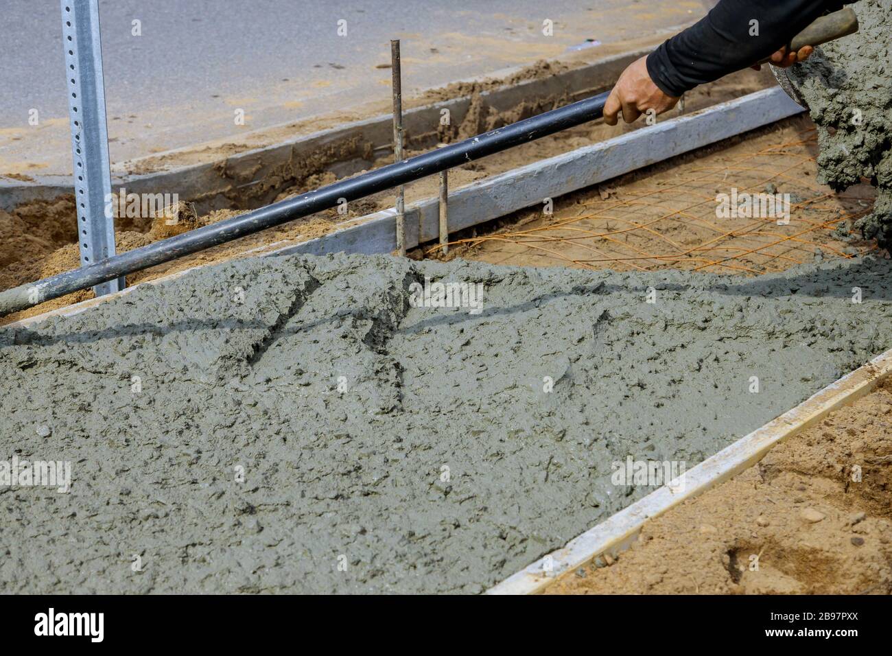 Building new concrete pavement for paving walkway to residential street ...