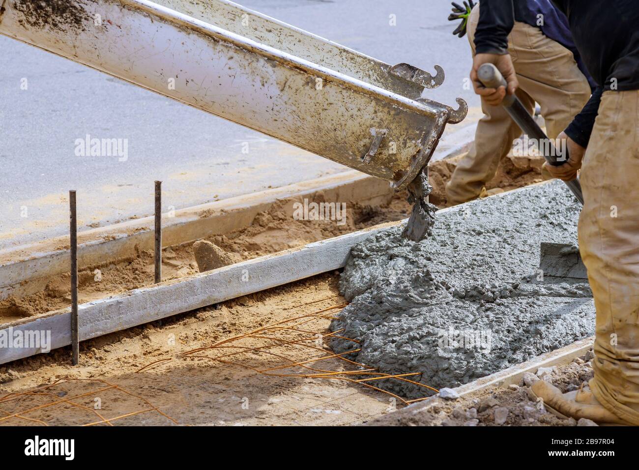 Construction of a concrete walkway around a residential rural house in ...