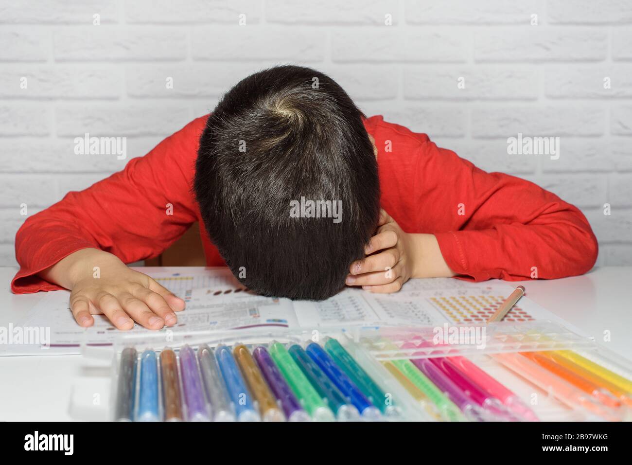 Upset boring schoolboy doing homework. Education, school, learning ...