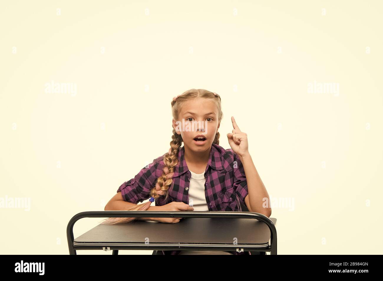 Homework idea. Little girl keeping finger raised isolated on white ...