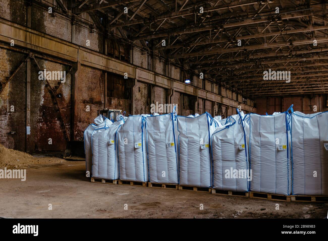 White polyethylene bags with factory products in warehouse Stock Photo ...