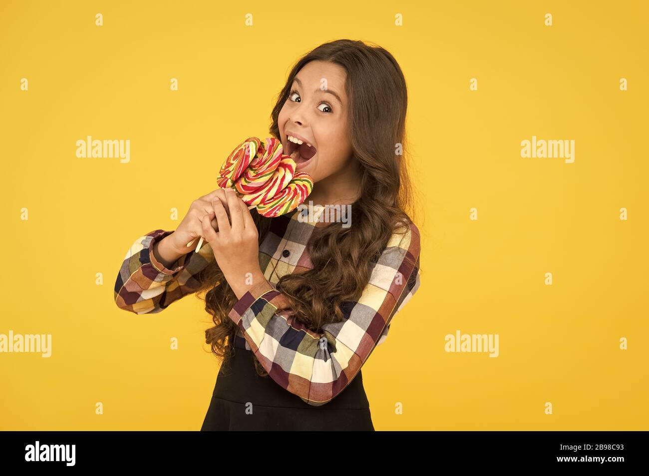 Crazy about sweets. Sugar addiction. Happy kid with sweet candy. Kid ...