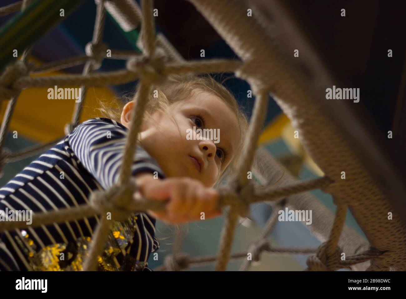 Active young girl climbing the spider web playground activity Stock ...