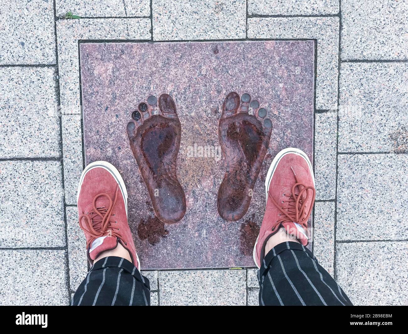 Two decorative footprints on street stone slabs. Studio Photo Stock ...