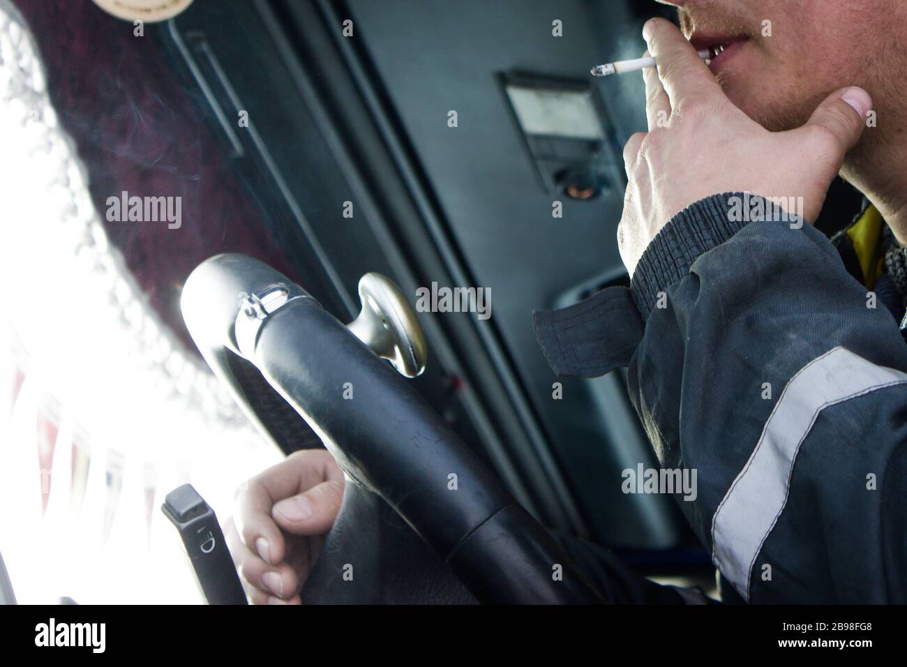 Smoking cigarette driver Stock Photo - Alamy