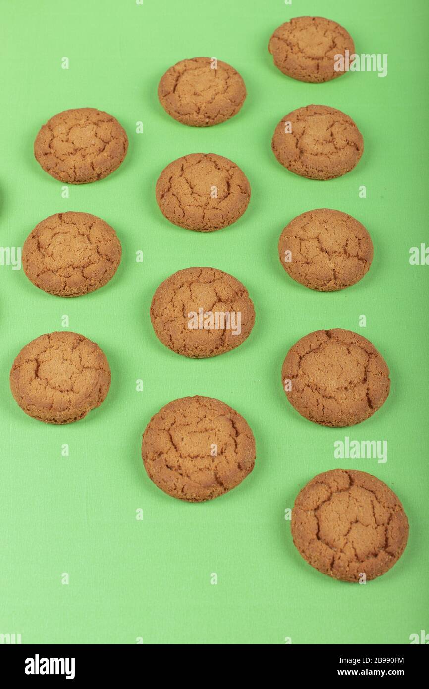 Biscuits on table with green background Stock Photo - Alamy