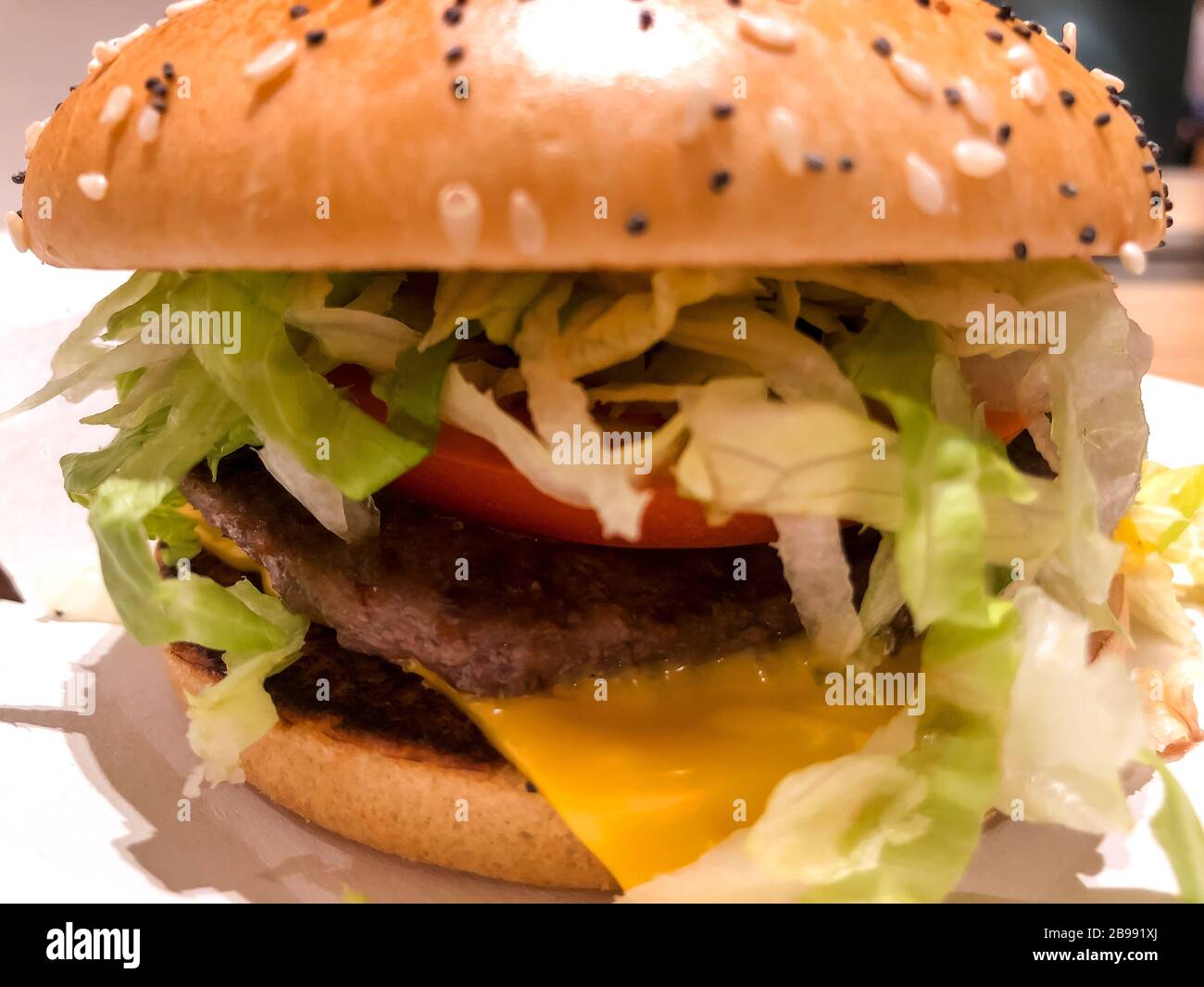 Delicious hamburger with cheddar and green lettuce Stock Photo - Alamy
