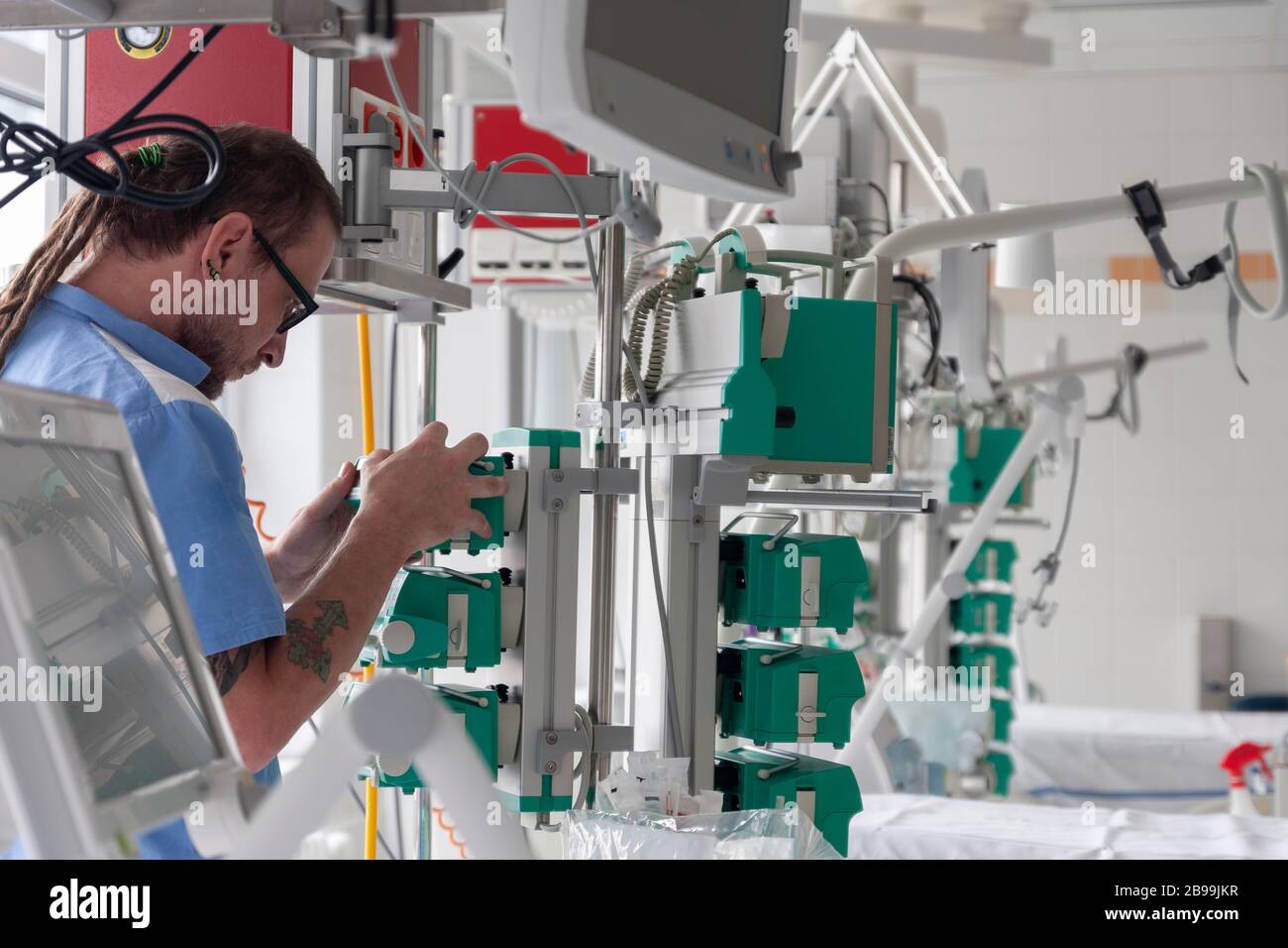 Male nurse checks the function of syringe infusion pump in ICU in ...