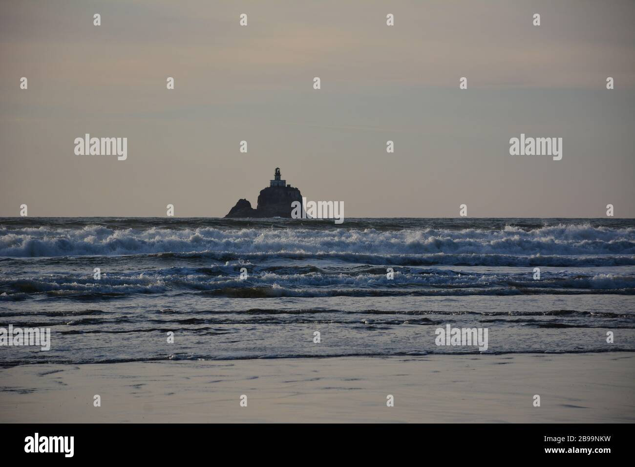 Tillamook Rock Lighthouse, seen silhouetted in the afternoon light from ...