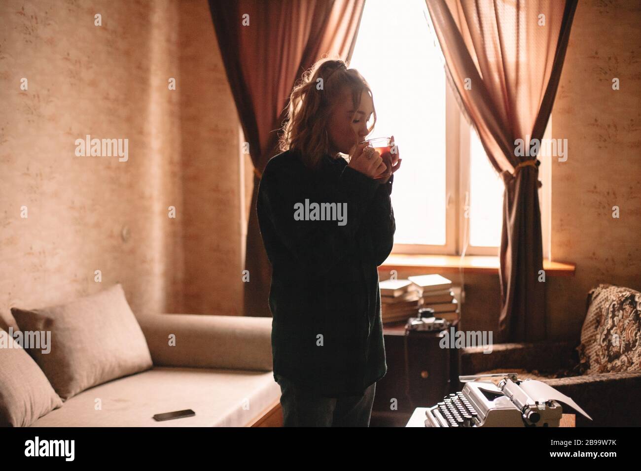 Woman standing in home interior hi-res stock photography and images - Alamy