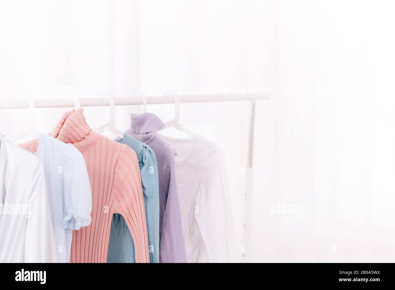 clothes hanging on hangers Stock Photo - Alamy