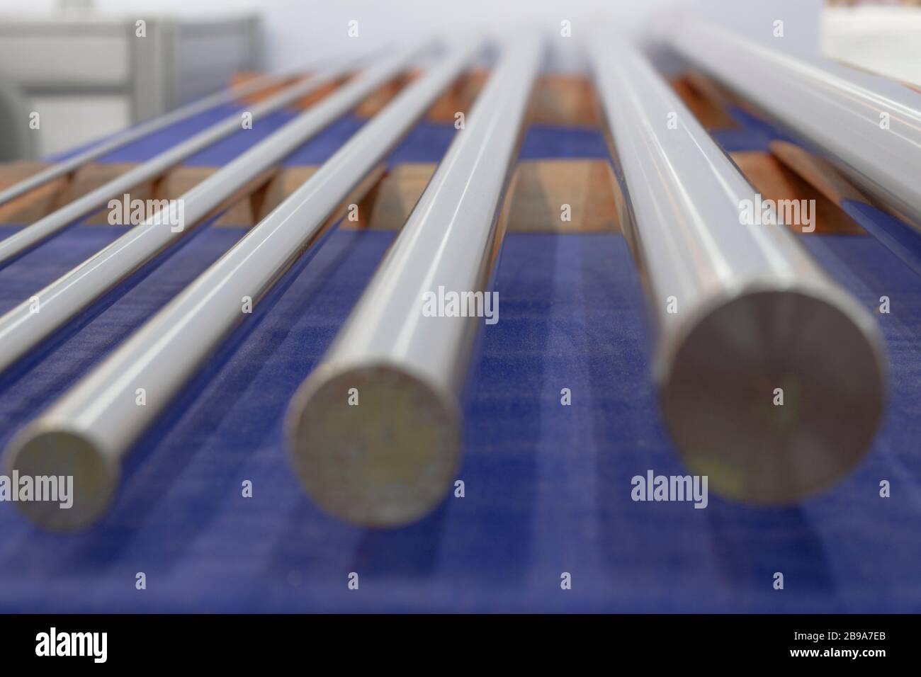blurred picture of Round stainless steel bars from grinding process ...