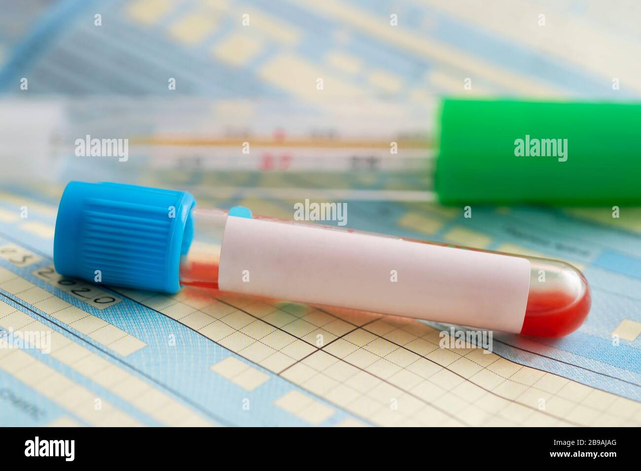 Blood test tube with thermometer for patient examination. Blood in test ...