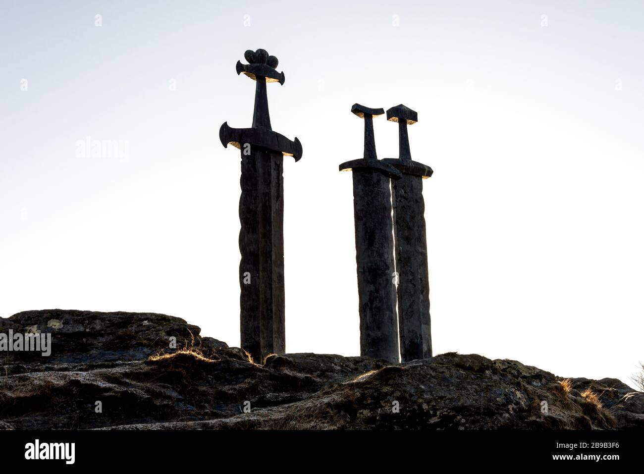 Three viking swords planted into ground on top of a rock at the sea ...