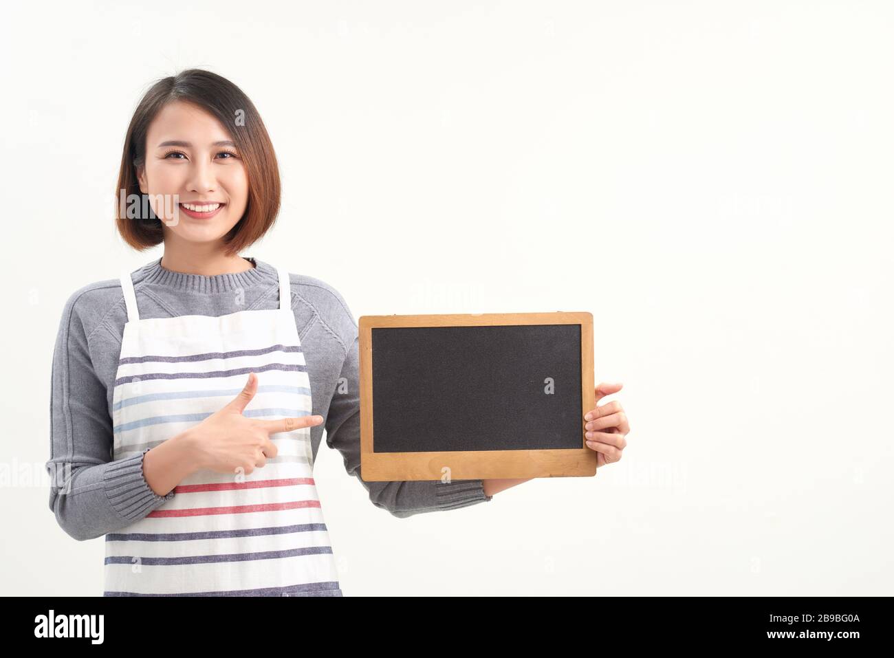 happy waitress holding blank chalkboard sign Stock Photo - Alamy