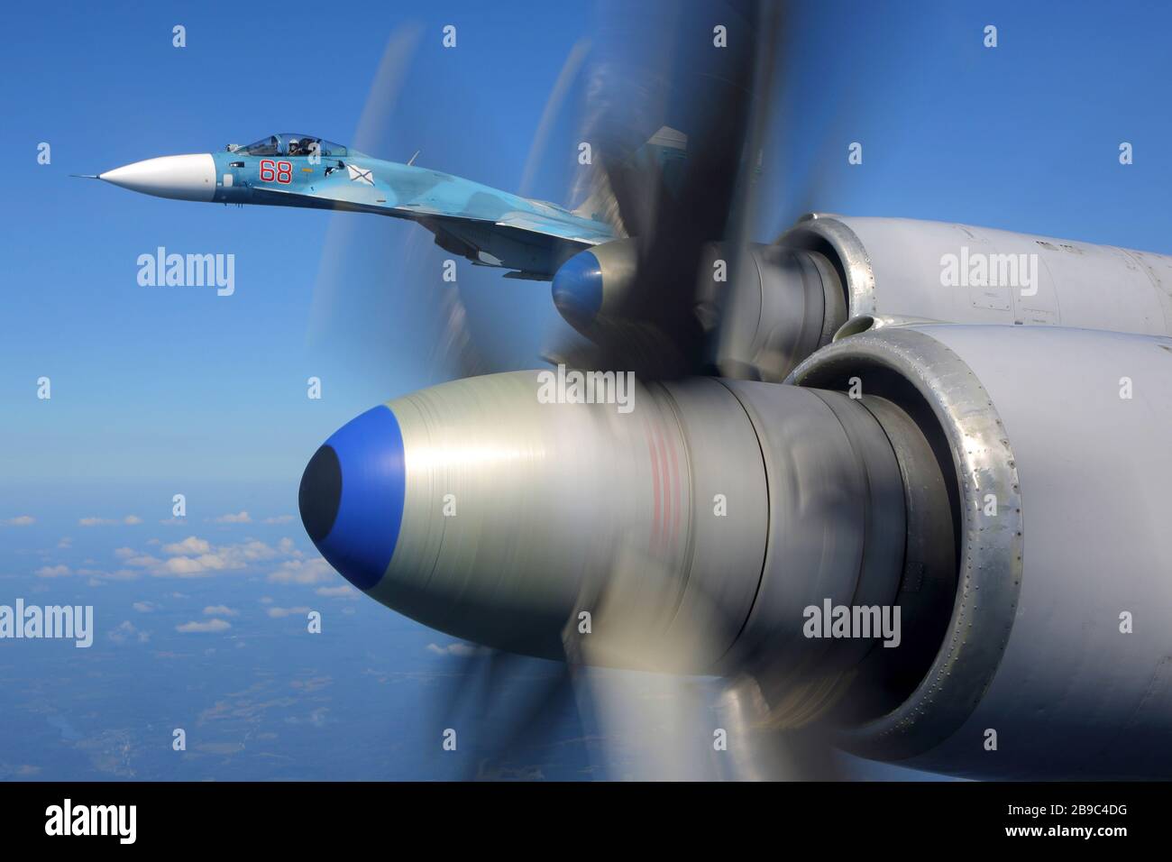 Tu-142MZ airplane in formation with a Su-33 jet fighter of the Russian ...