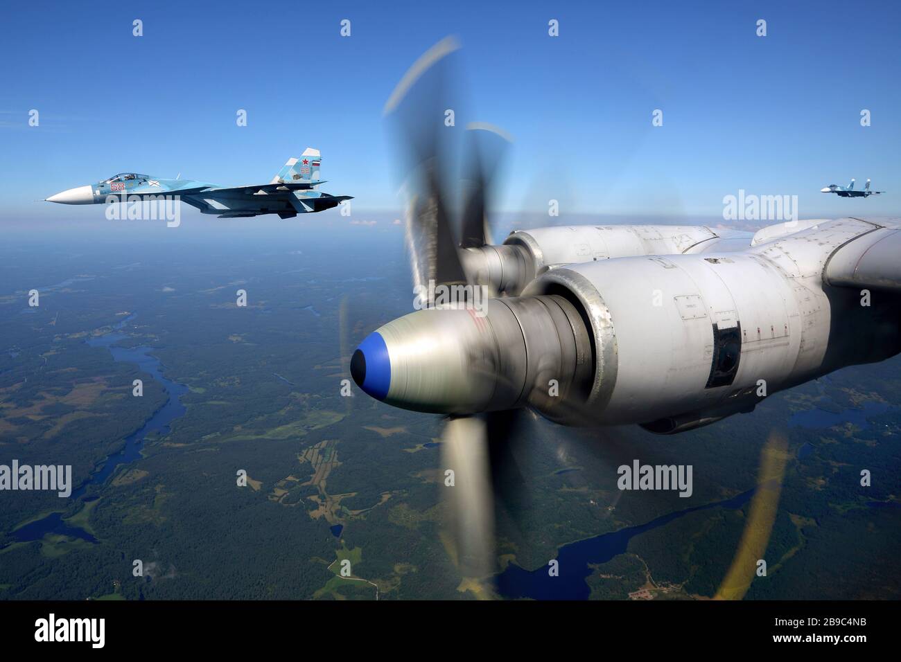 Tu-142MZ airplane in formation with a Su-33 jet fighters of the Russian ...