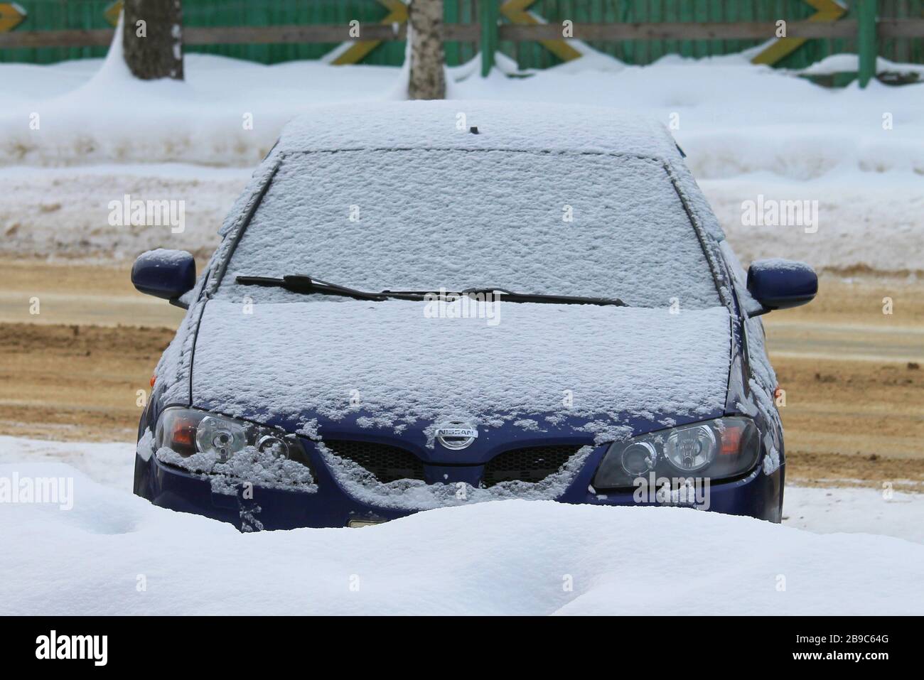 02.02.2020 - Syktyvkar, Russia. Nissan car covered with snow stands on ...