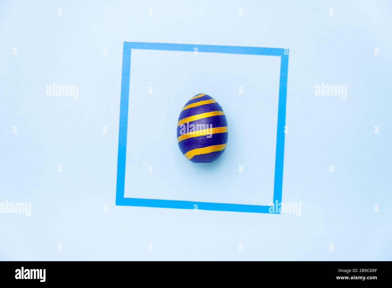 Happy Easter. One easter egg trendy colored classic blue, white and ...