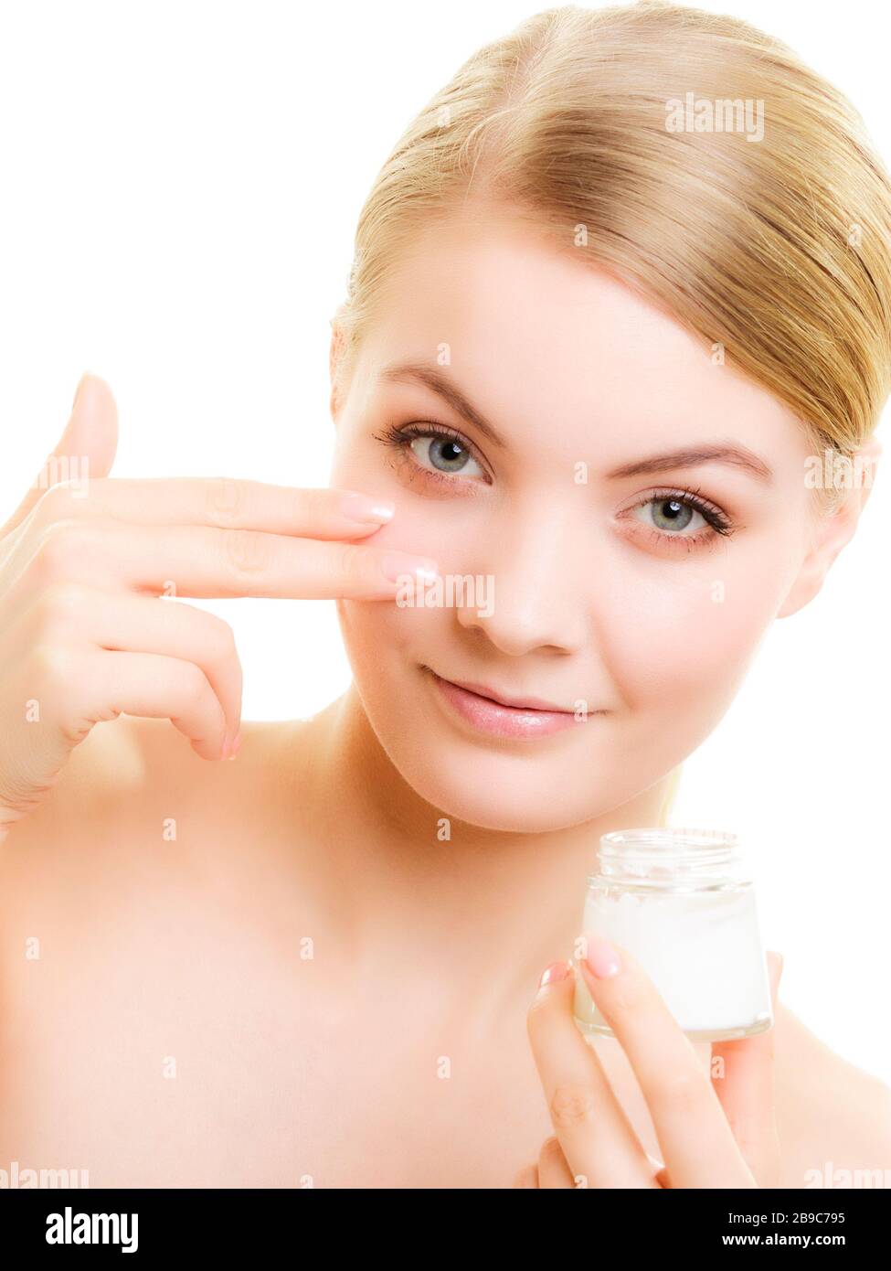 Skincare. Young woman taking care of her dry complexion. Girl applying ...