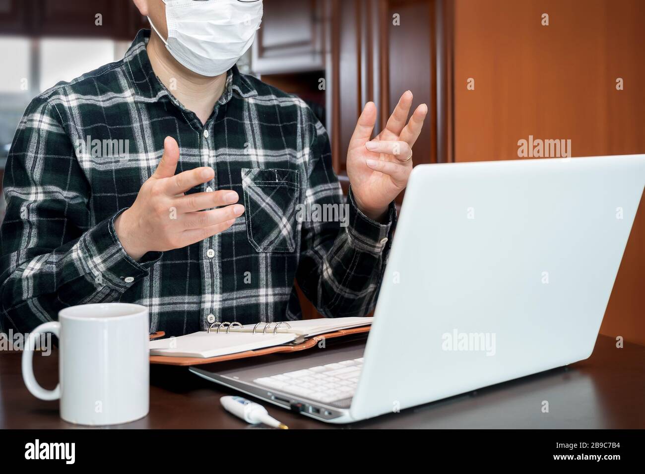 An Asian man who is self-isolated and working from home because of a ...