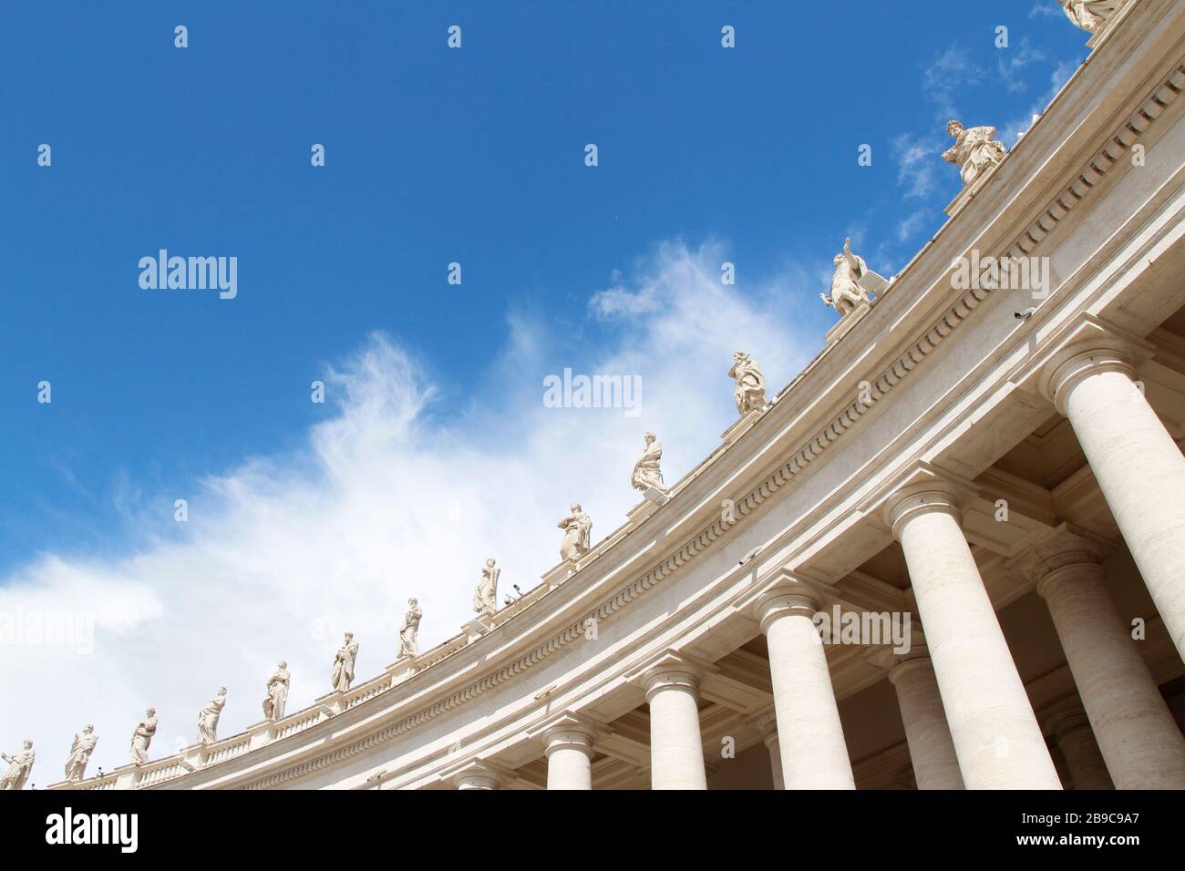 A group of Saint Statues on the colonnades of St Peter's Square with ...