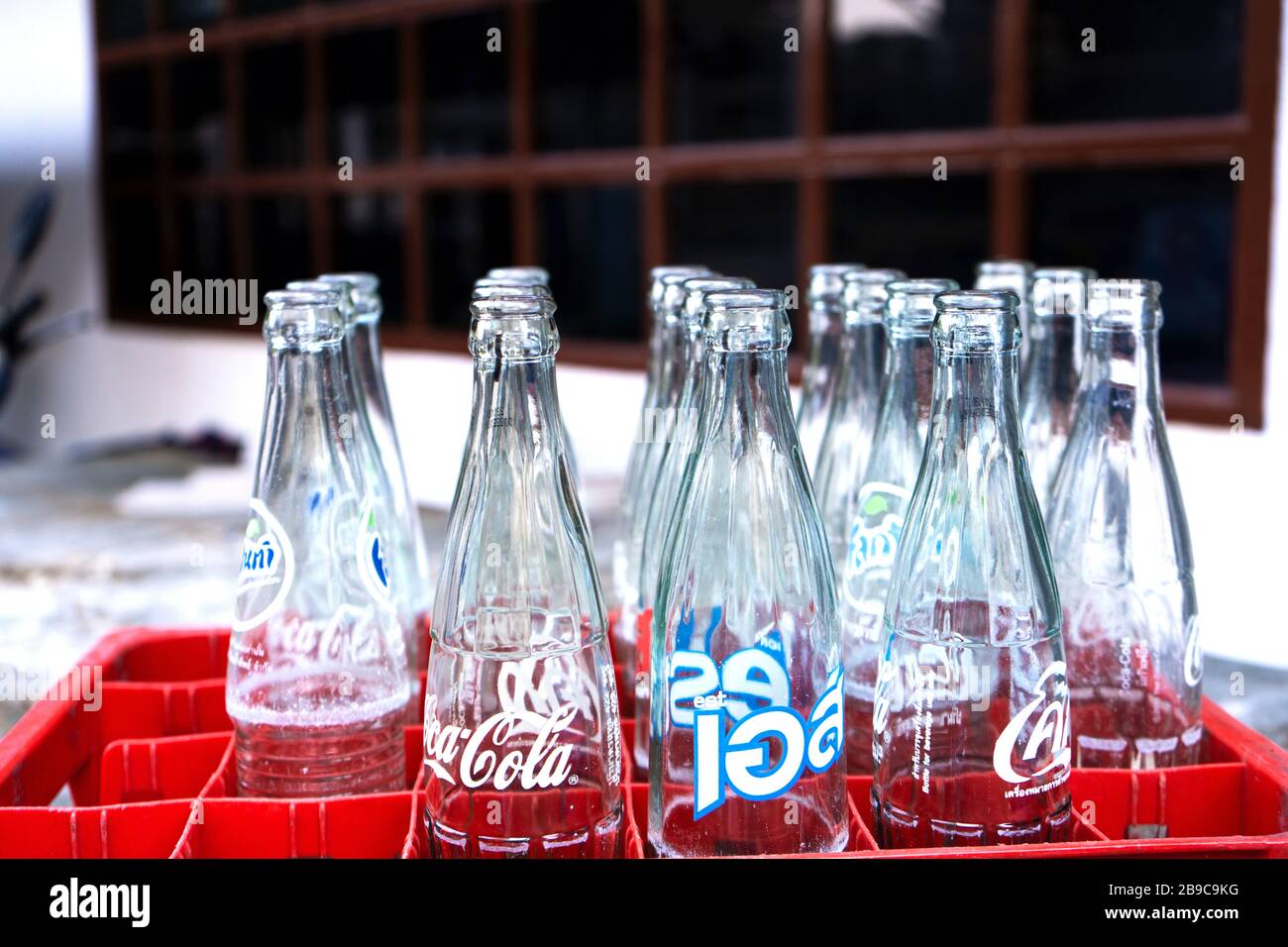 Box with empty glass bottles of Coca Cola, and other drinks. Recycling ...