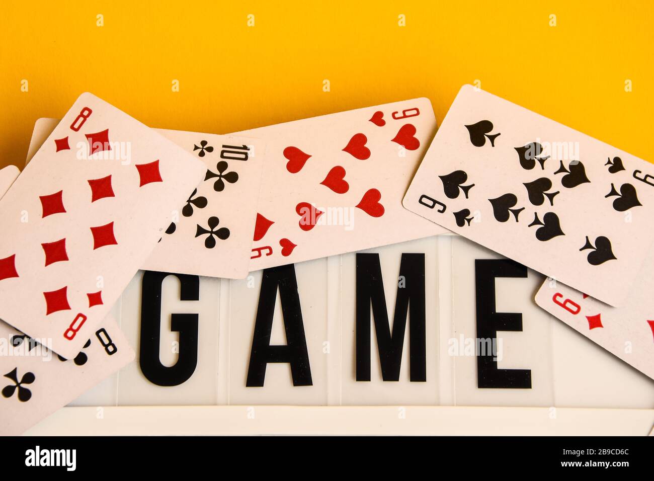 Game night text on lightbox with playing cards on yellow background ...