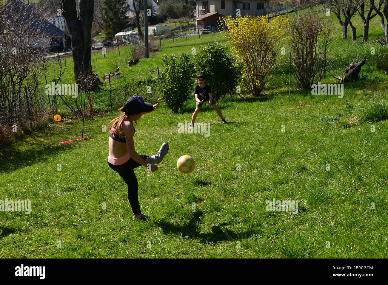 Brother and sister playing soccer ball Stock Photo - Alamy